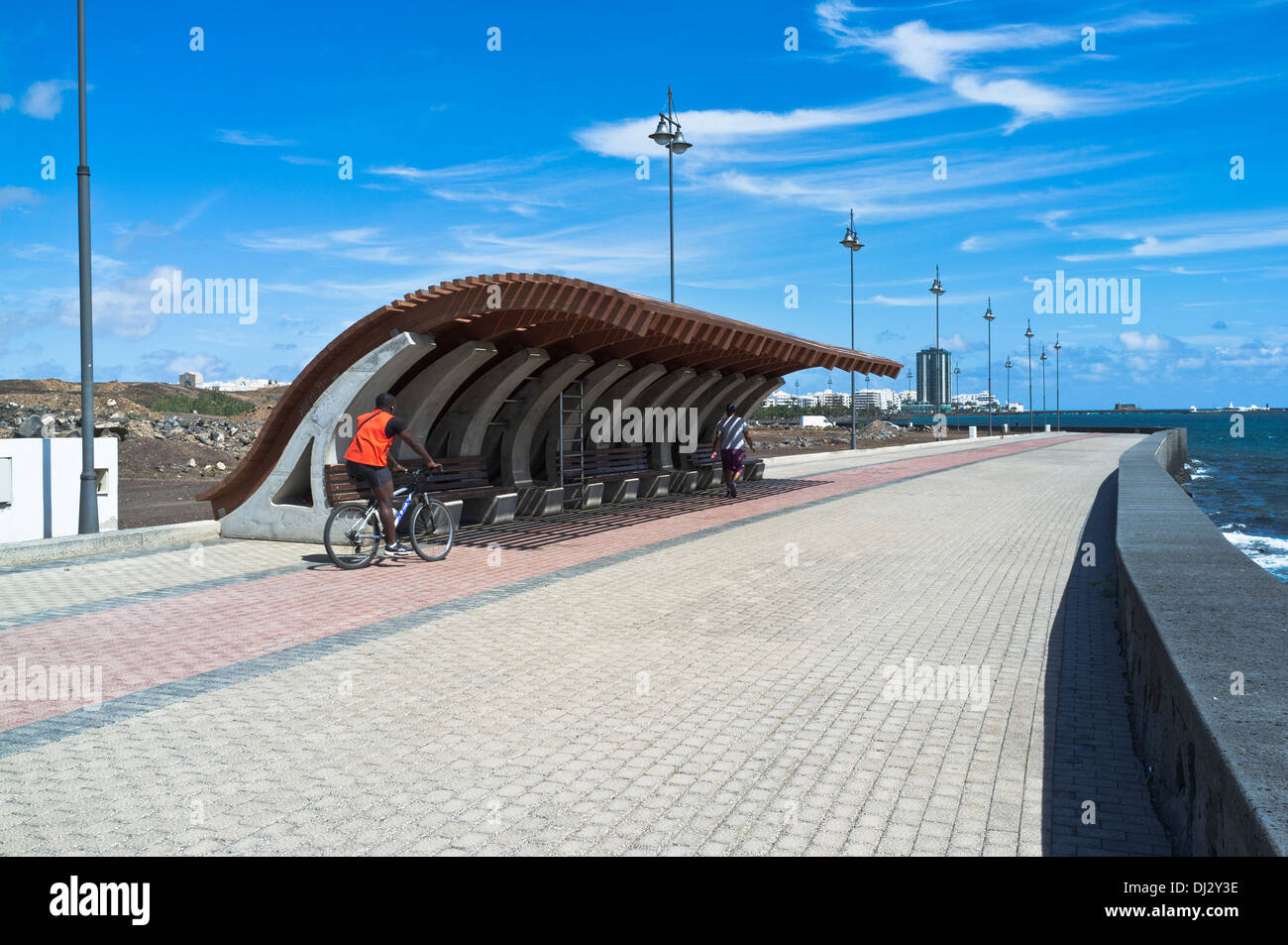 dh ARRECIFE LANZAROTE Man riding bicycles on coastal cycle path and ...