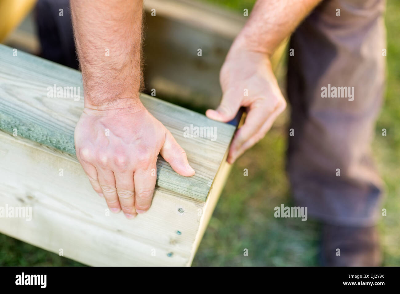 Manual Worker's Hand Fixing Wood At Site Stock Photo - Alamy