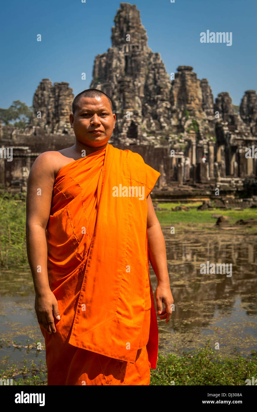 A Buddhist Monk standing in front of Bayon Temple in Cambodia Stock ...