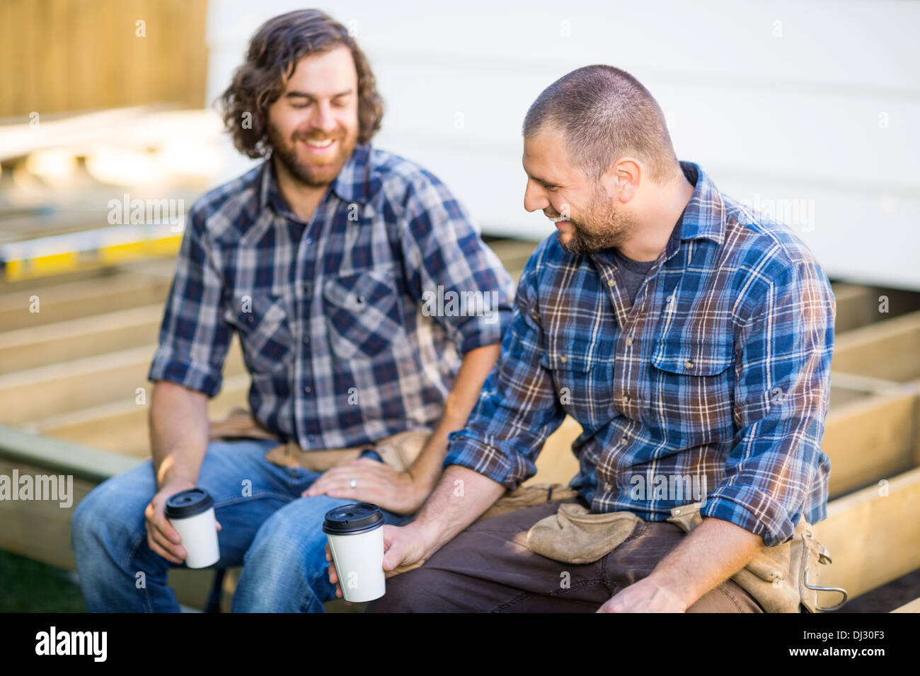 Construction Workers Holding Disposable Coffee Cups On Wooden Fr Stock ...