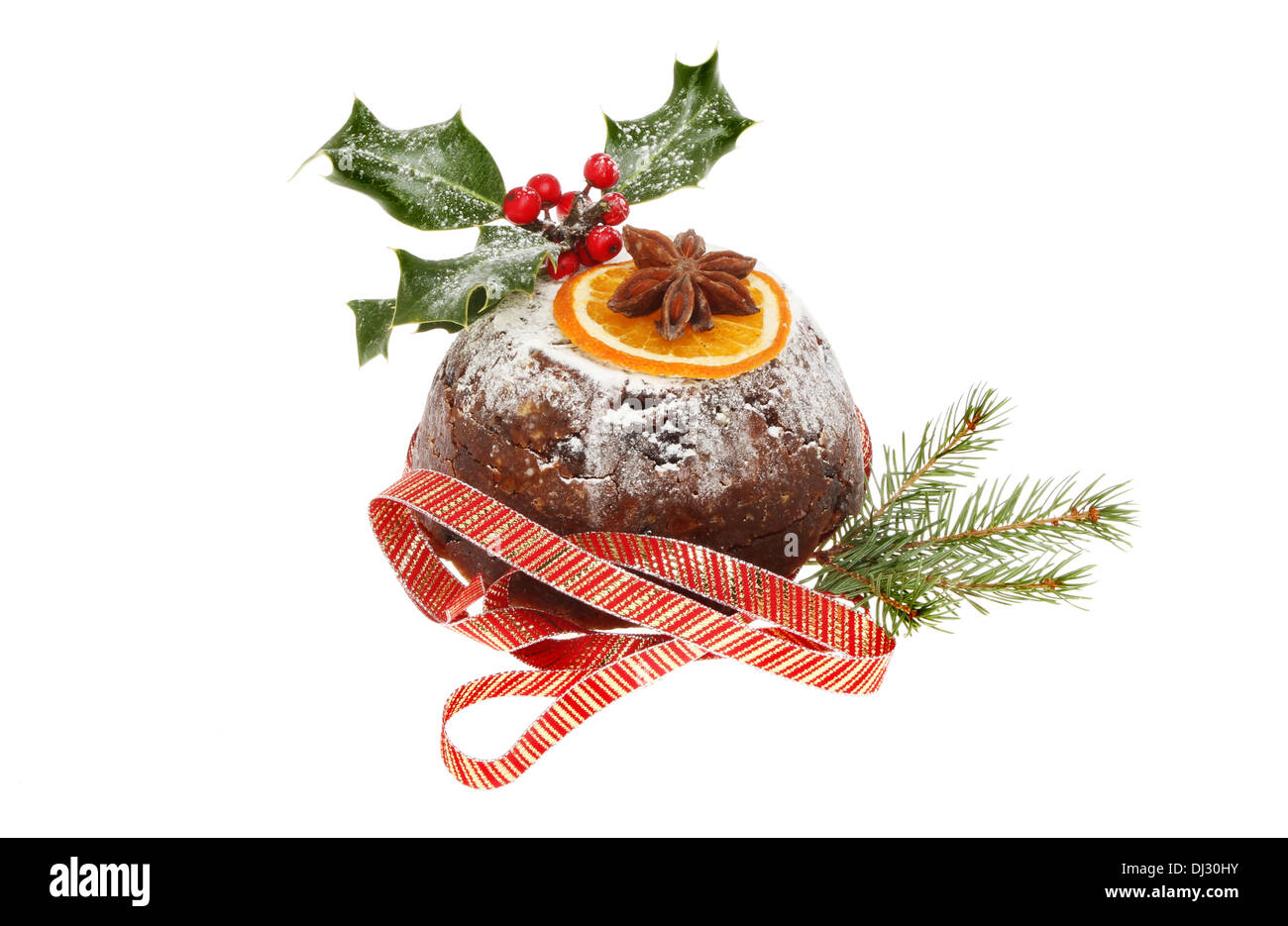 Christmas pudding decorated with seasonal foliage, star anise and ...