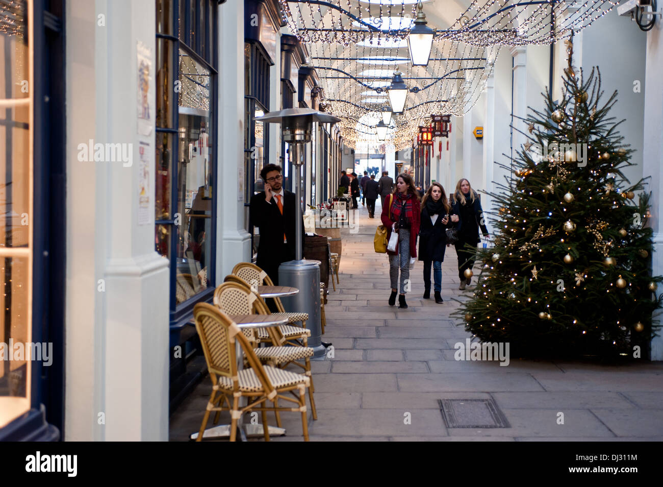 London, UK - November 19, 2013:People stroll in the Royal Opera Arcade ...
