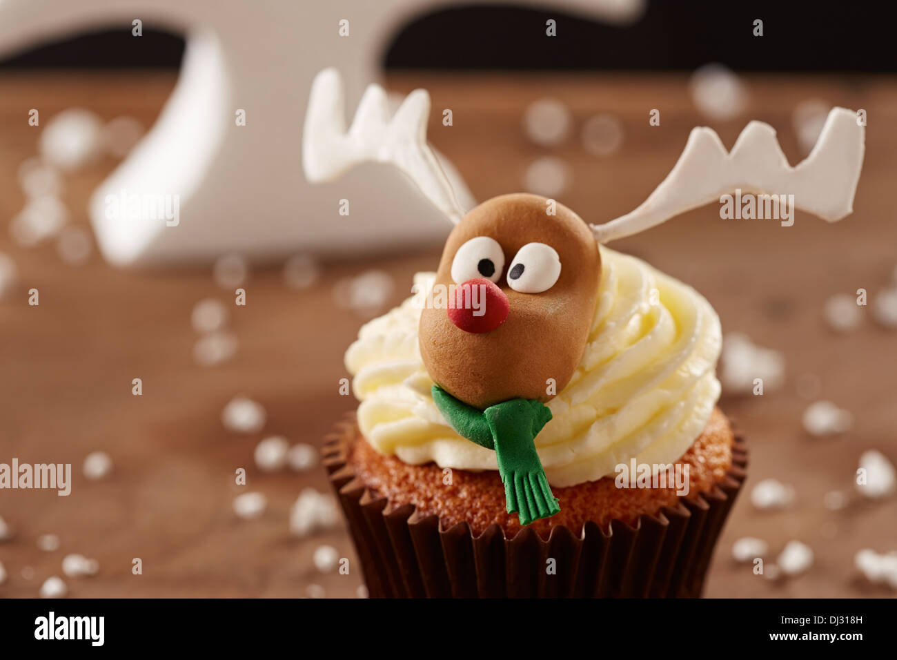 Rudolph reindeer cupcake on Christmas tree background Stock Photo - Alamy