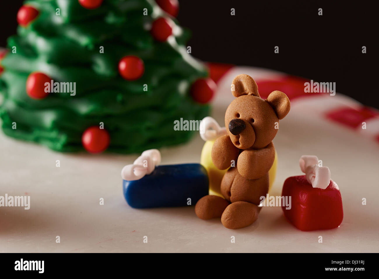 Fondant Christmas tree cake with a kid and presents detail Stock Photo ...