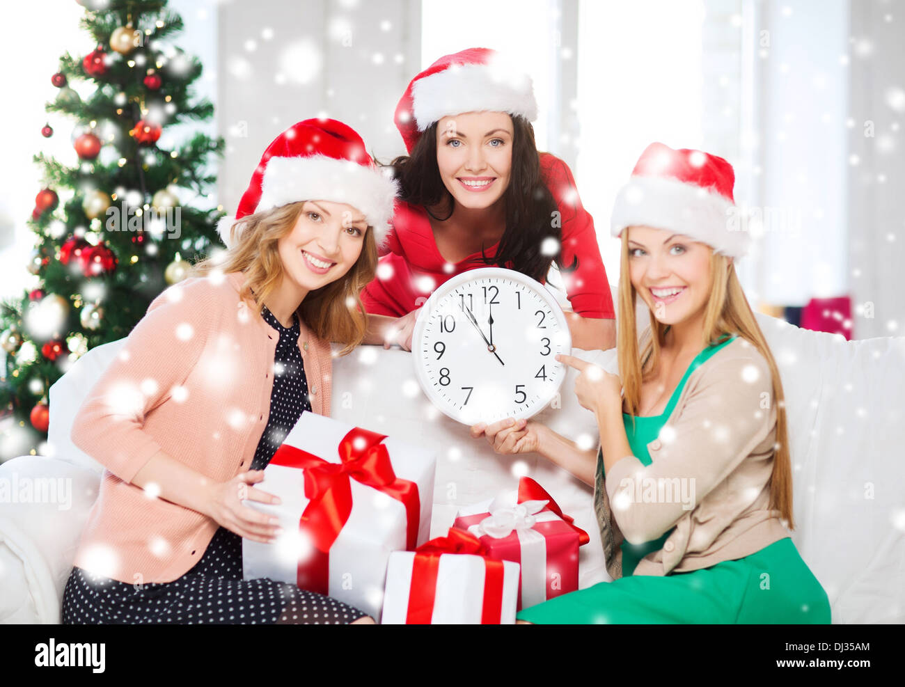 women in santa helper hats with clock showing 12 Stock Photo - Alamy
