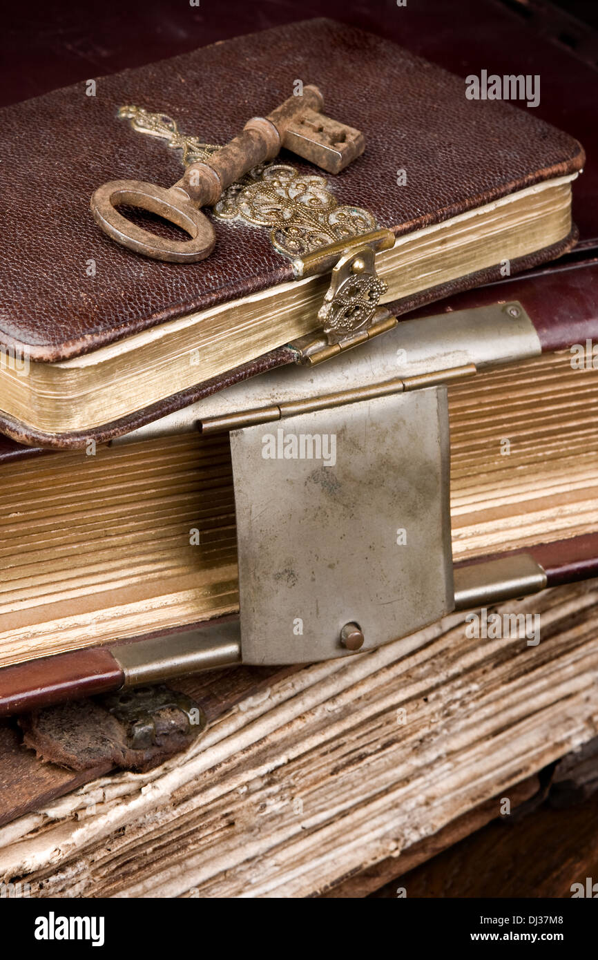Old key lying on antique books with locks Stock Photo - Alamy