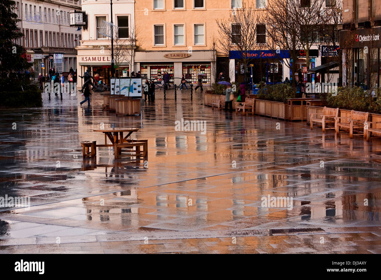 Colourful reflections of buildings showing on the wet City Centre ...