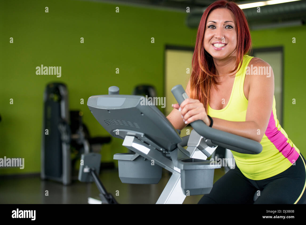 Indoor bicycle cycling in gym Stock Photo - Alamy