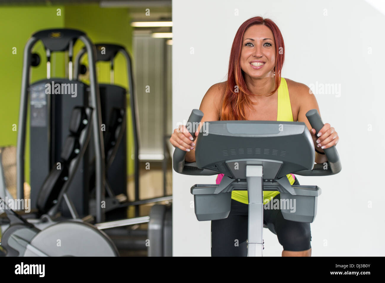 Indoor bicycle cycling in gym Stock Photo - Alamy