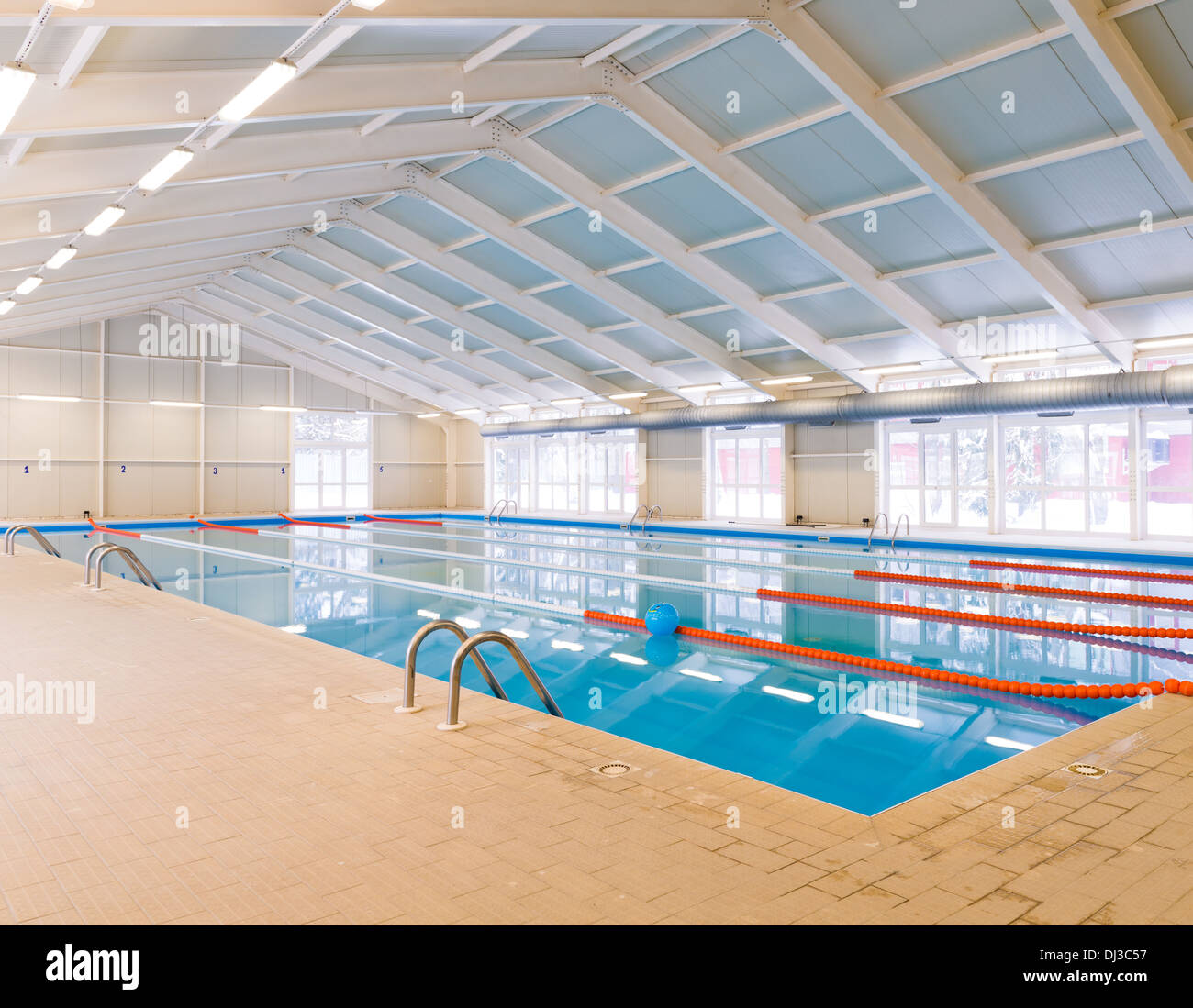 Indoors swimming pool with blue water Stock Photo - Alamy