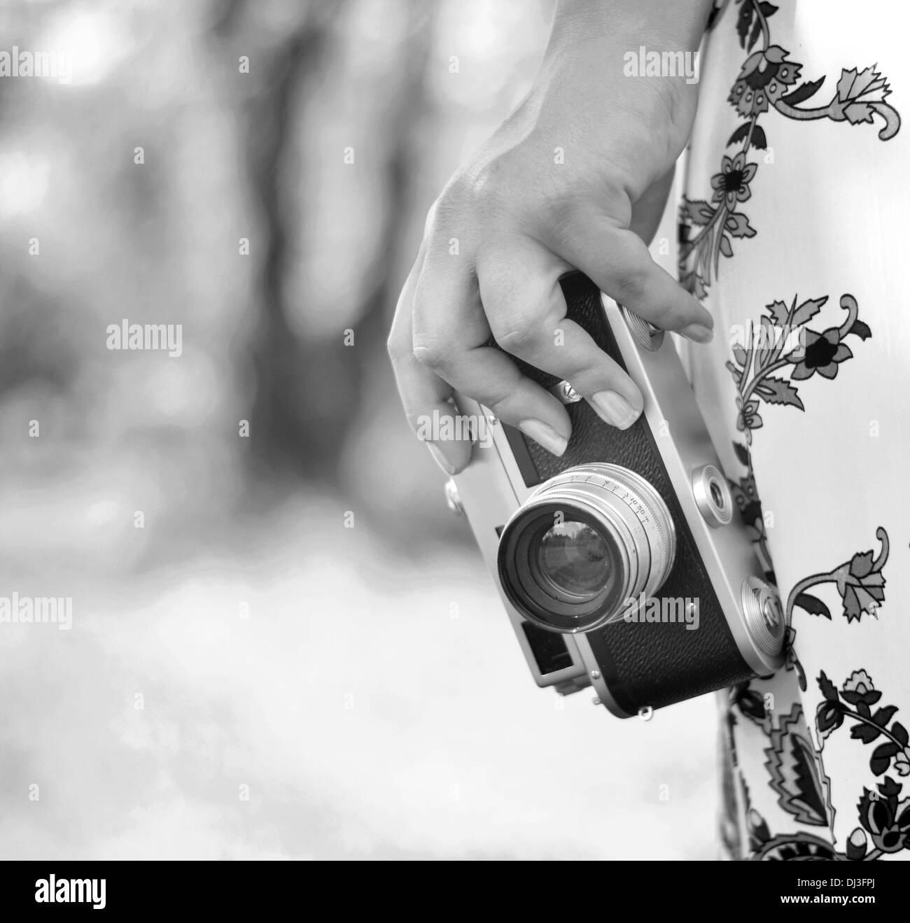 Woman holding camera hand Black and White Stock Photos & Images - Alamy