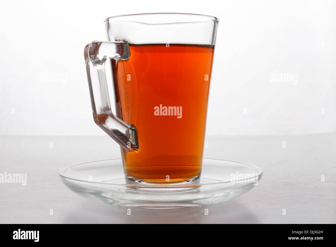 tea in a tall glass cup against white background Stock Photo - Alamy