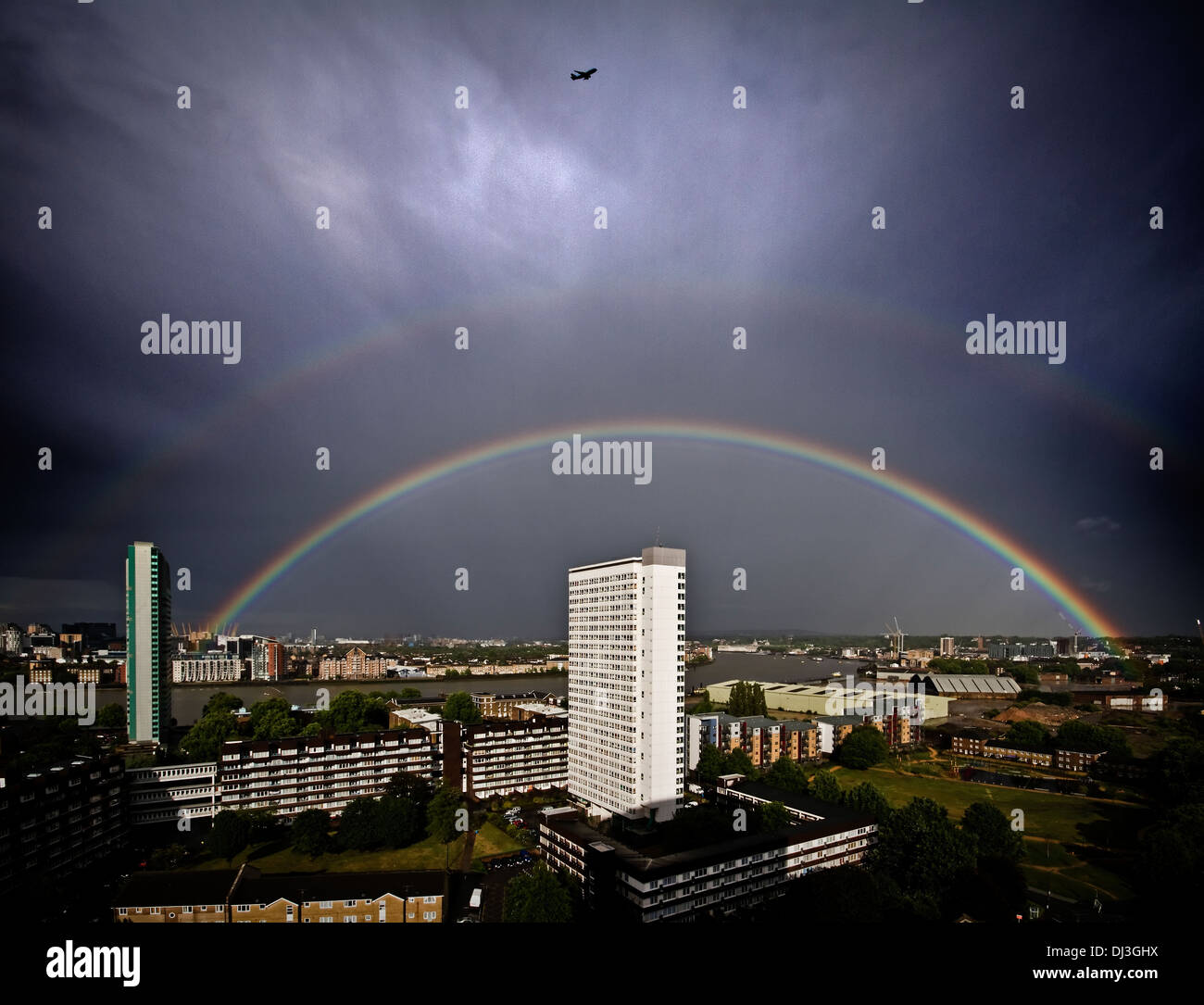 A colourful rainbow arc breaks after a brief rainstorm over a south ...
