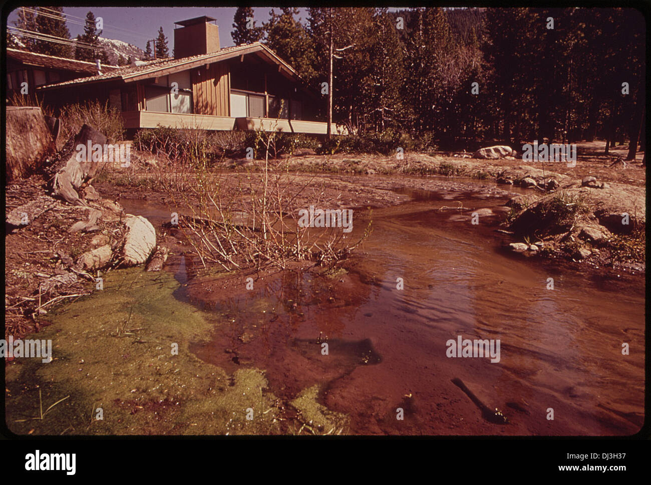 This image shows a lake contaminated with silt alongside a newly ...