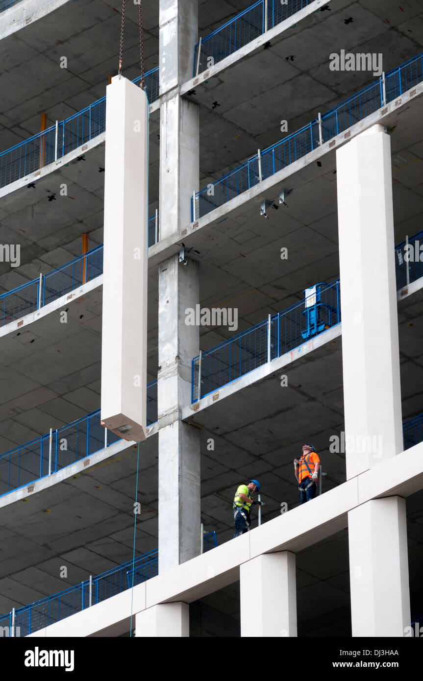 Concrete beam being lifted into place on a construction site, No.1 St ...