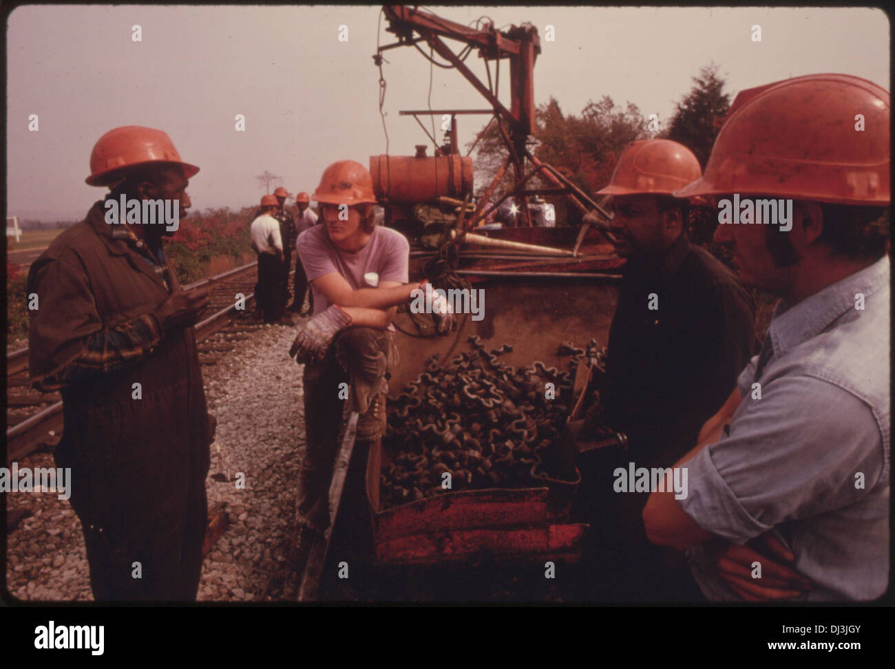 A Southern Railway track repair crew works with equipment to remove old ...