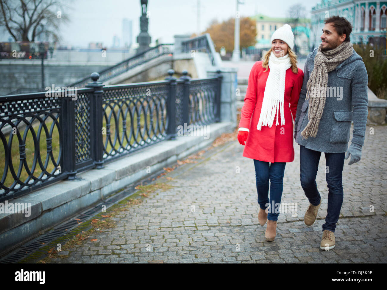 Portrait of affectionate couple taking a walk in the city Stock Photo ...