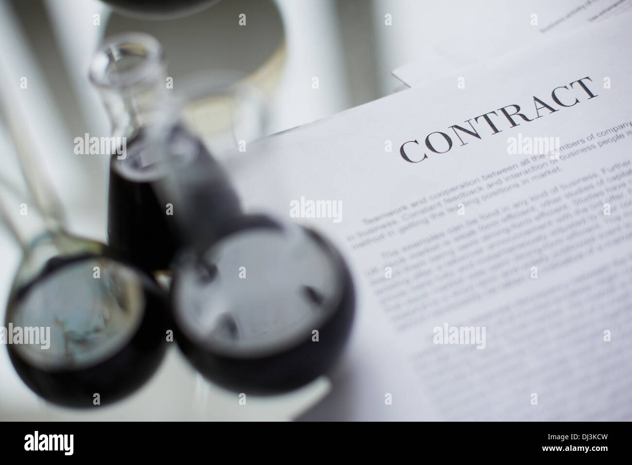 Test-tubes with liquid oil over paper agreement Stock Photo - Alamy