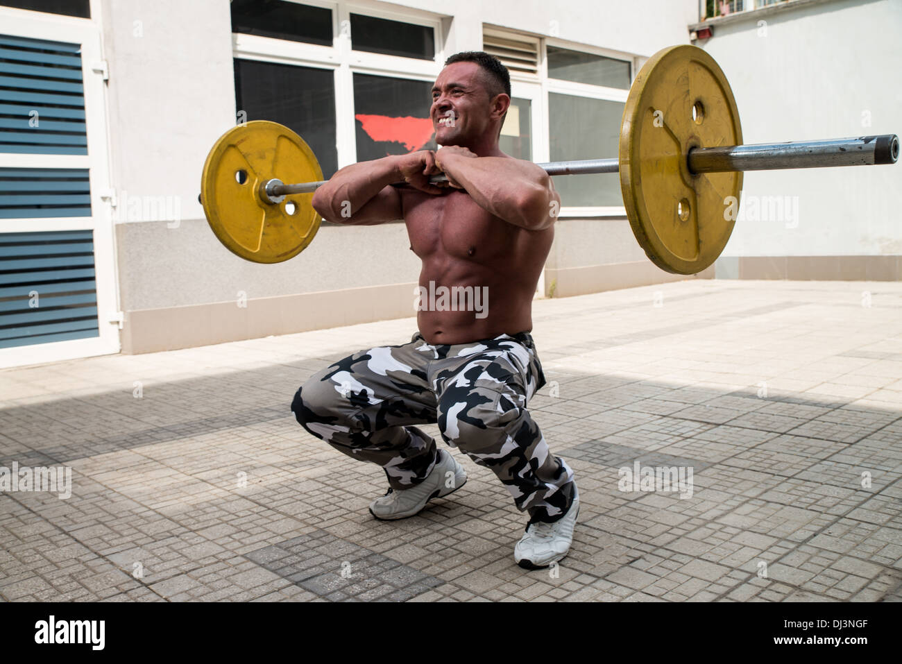 Bodybuilder Doing Front Squats With Barbells Stock Photo - Alamy