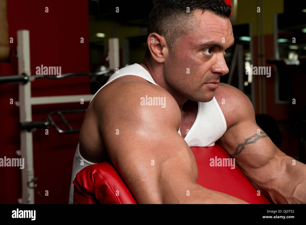Man In The Gym Exercising Biceps With Barbell Stock Photo - Alamy
