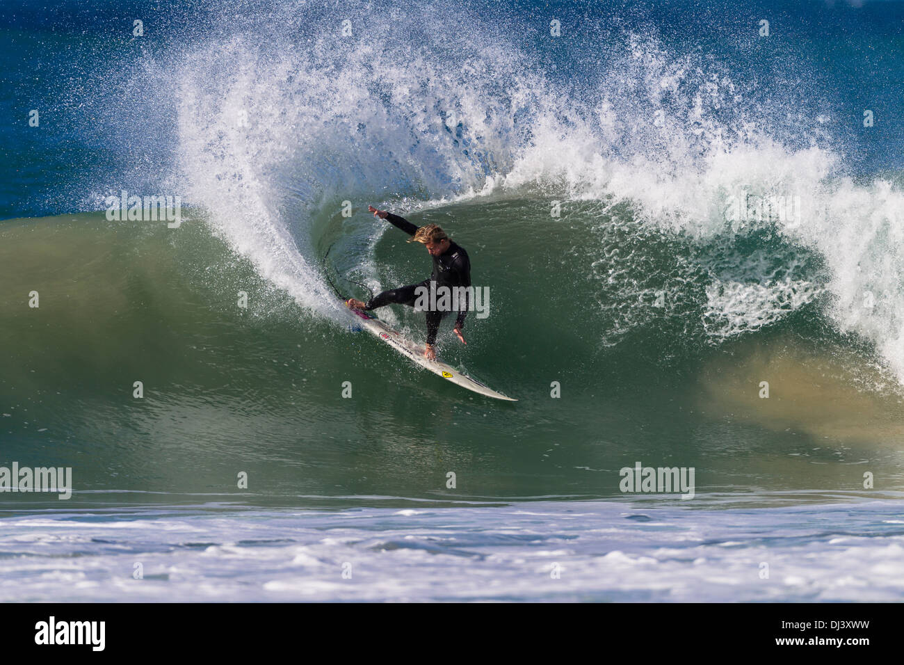Surfing surfer does a power carving turn with balance and skill on ...