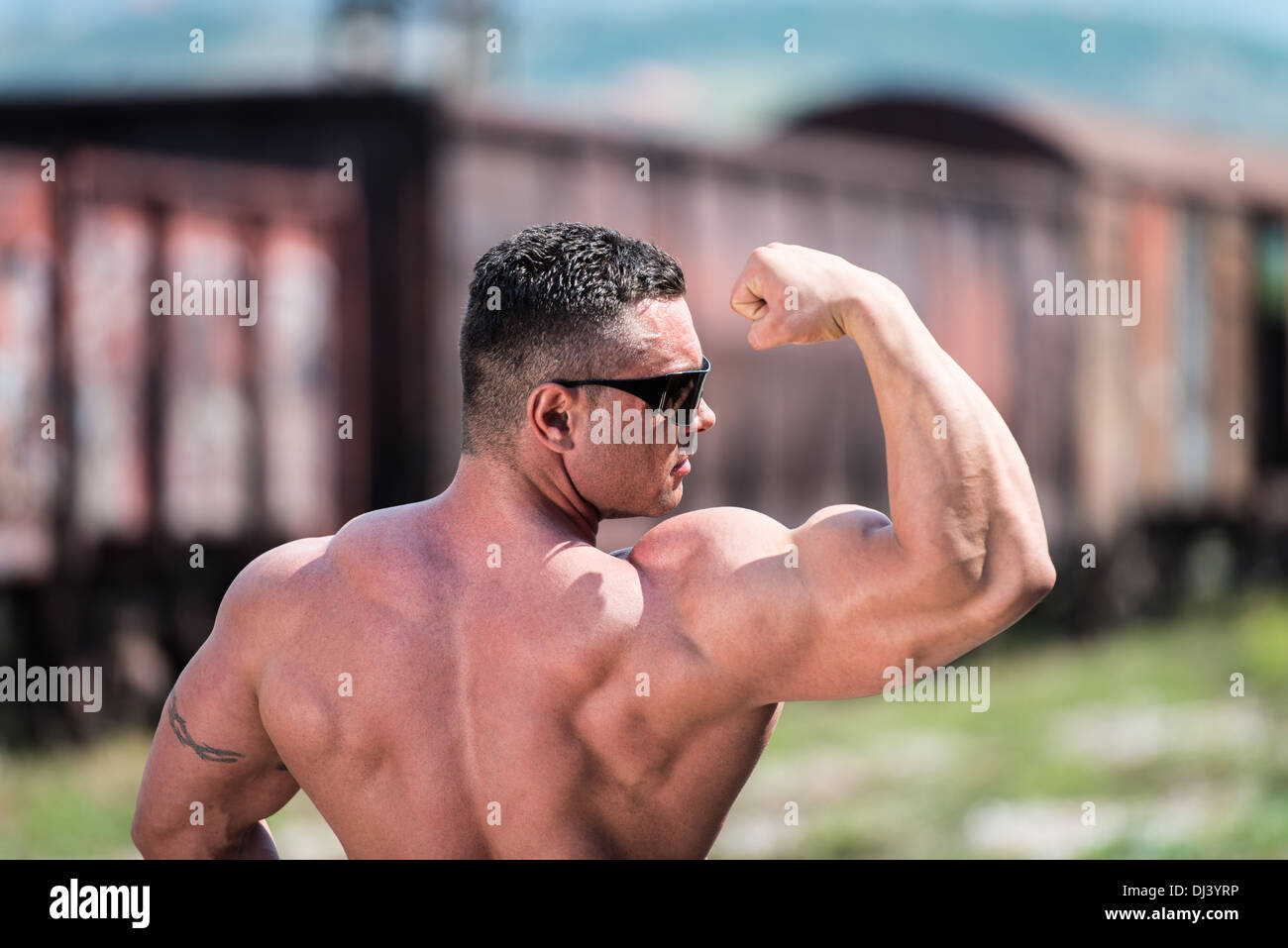 Flexing biceps man hi-res stock photography and images - Alamy