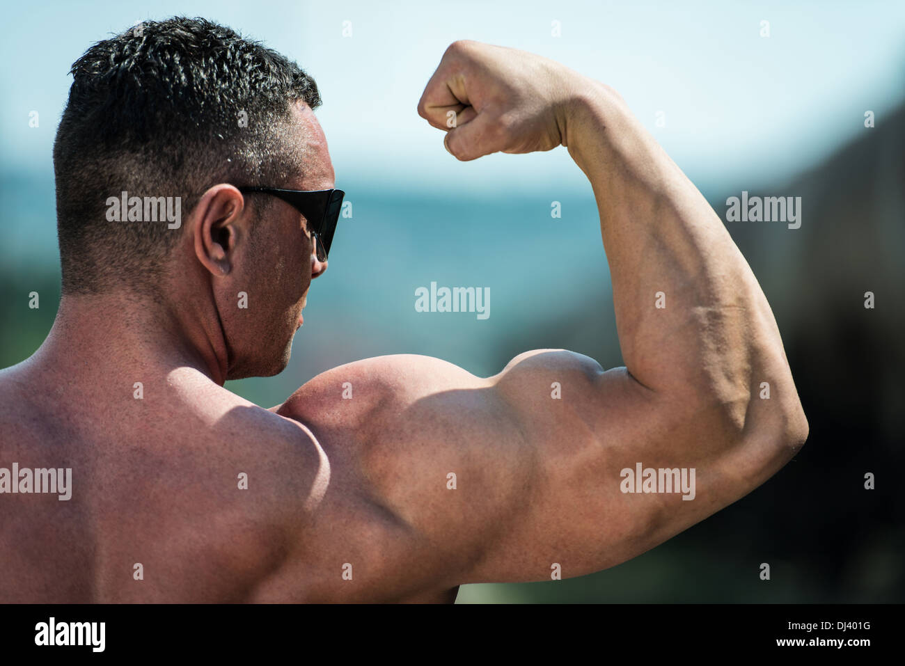 Man Athlete Showing Biceps Stock Photo - Alamy