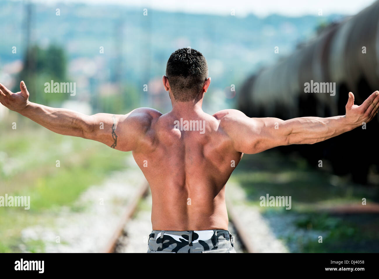 Man Showing His Back Double Biceps Stock Photo - Alamy