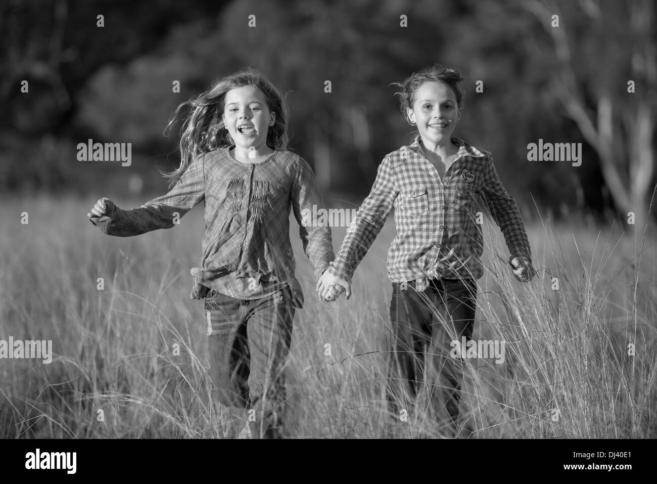 Two girls running holding hands Stock Photo - Alamy Two girls running holding hands Stock Photo - Alamy