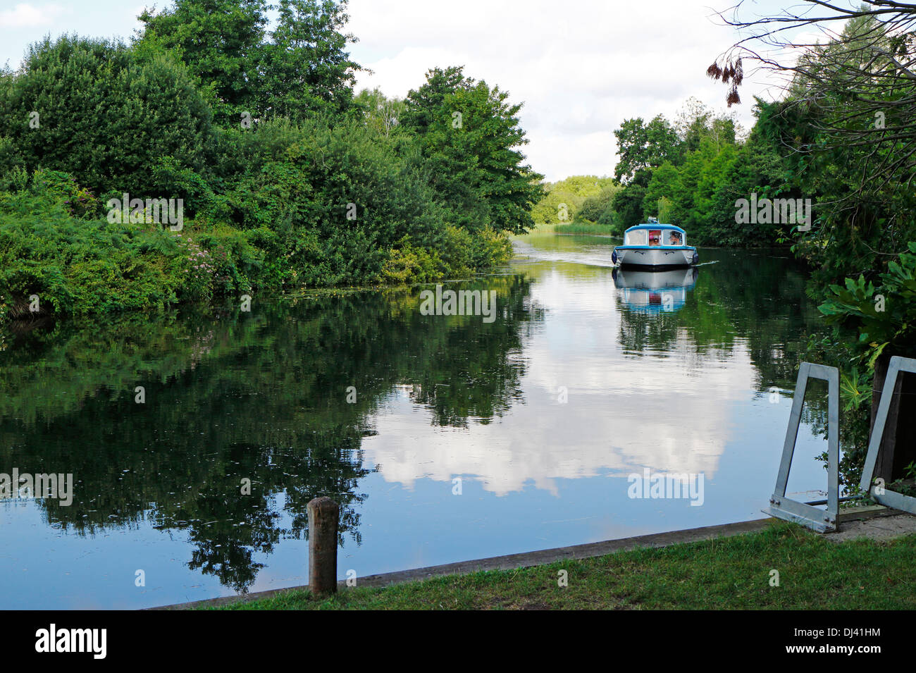 A cruiser on the River Bure on the Norfolk Broads at Belaugh, Norfolk ...