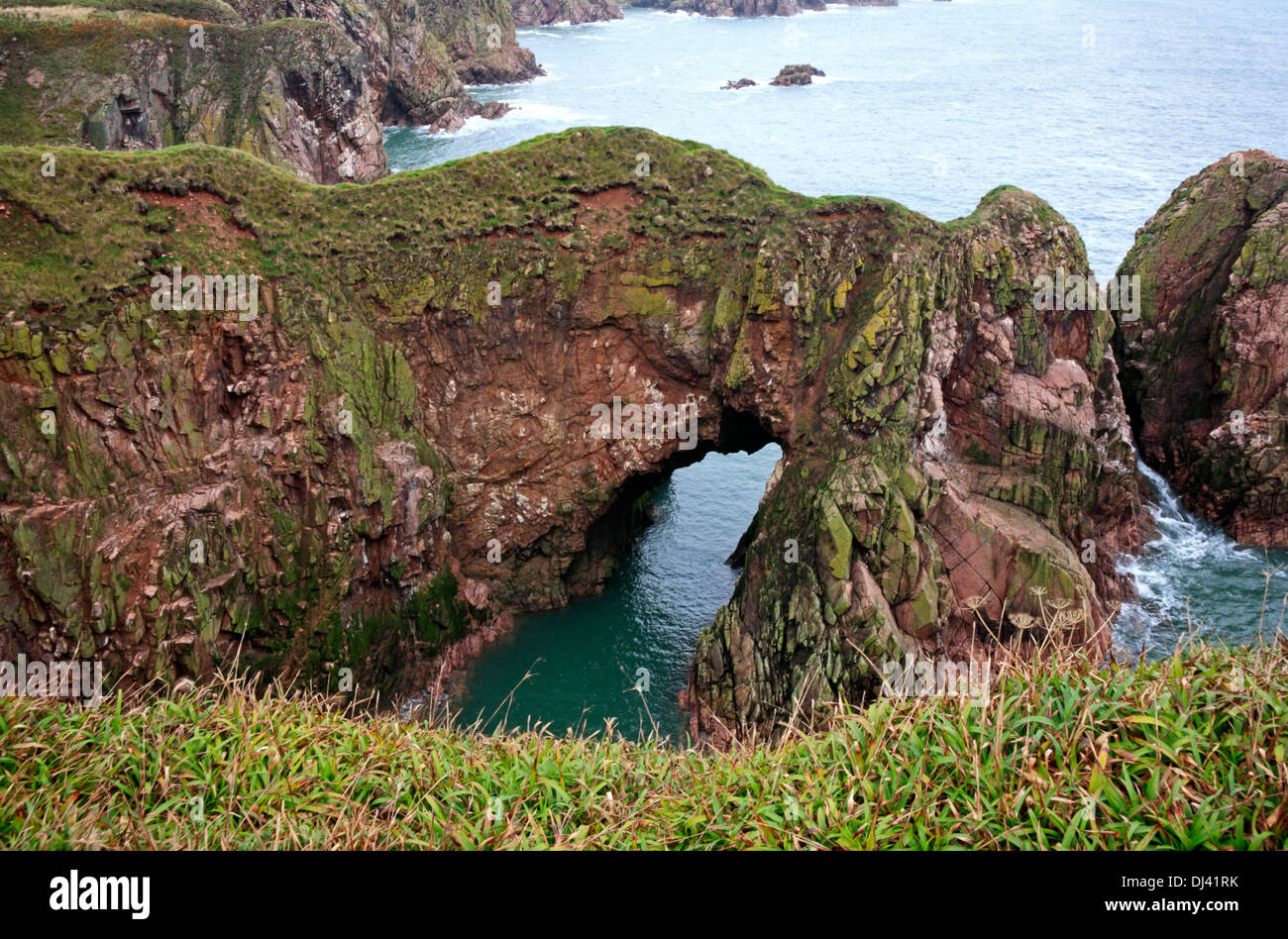 An arch in the granite cliffs at Bullers of Buchan, Aberdeenshire ...