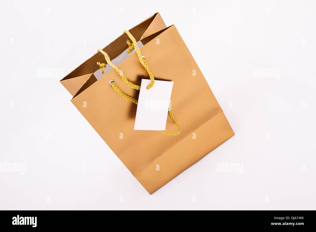 A gold gift bag isolated Stock Photo - Alamy