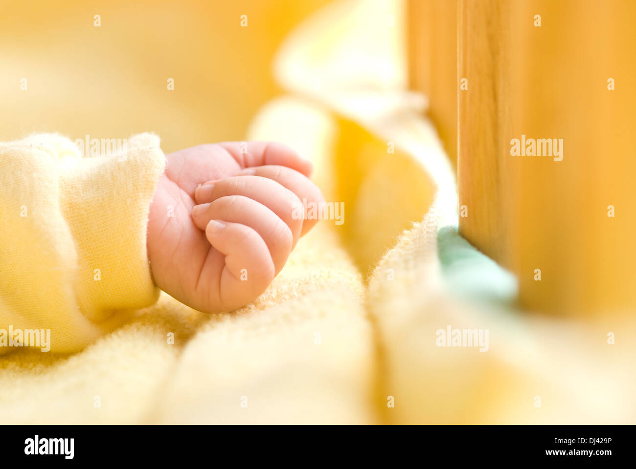 infant hand in baby bed with wooden Stock Photo - Alamy
