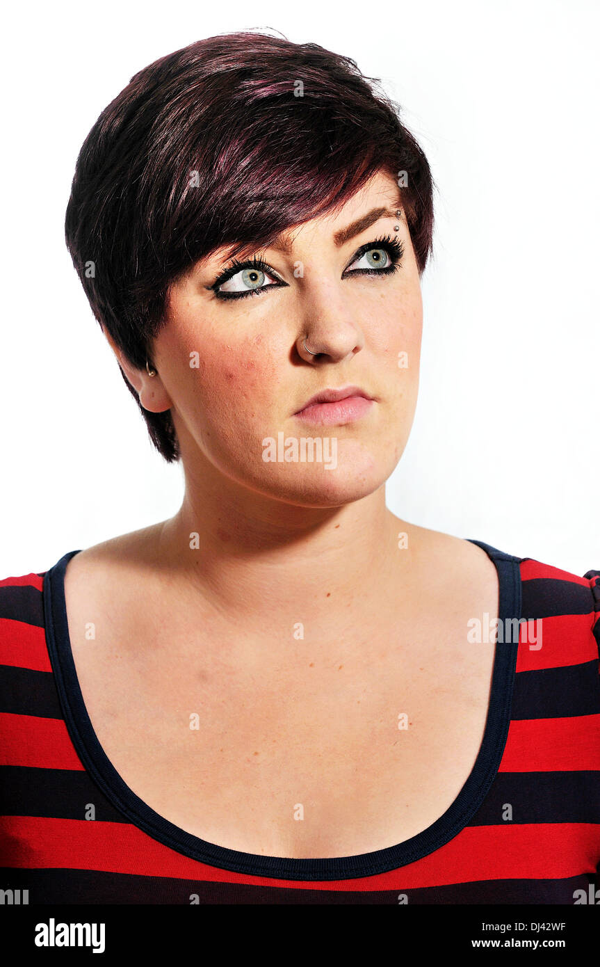 A young woman photographed on white looks up and to the left of the ...