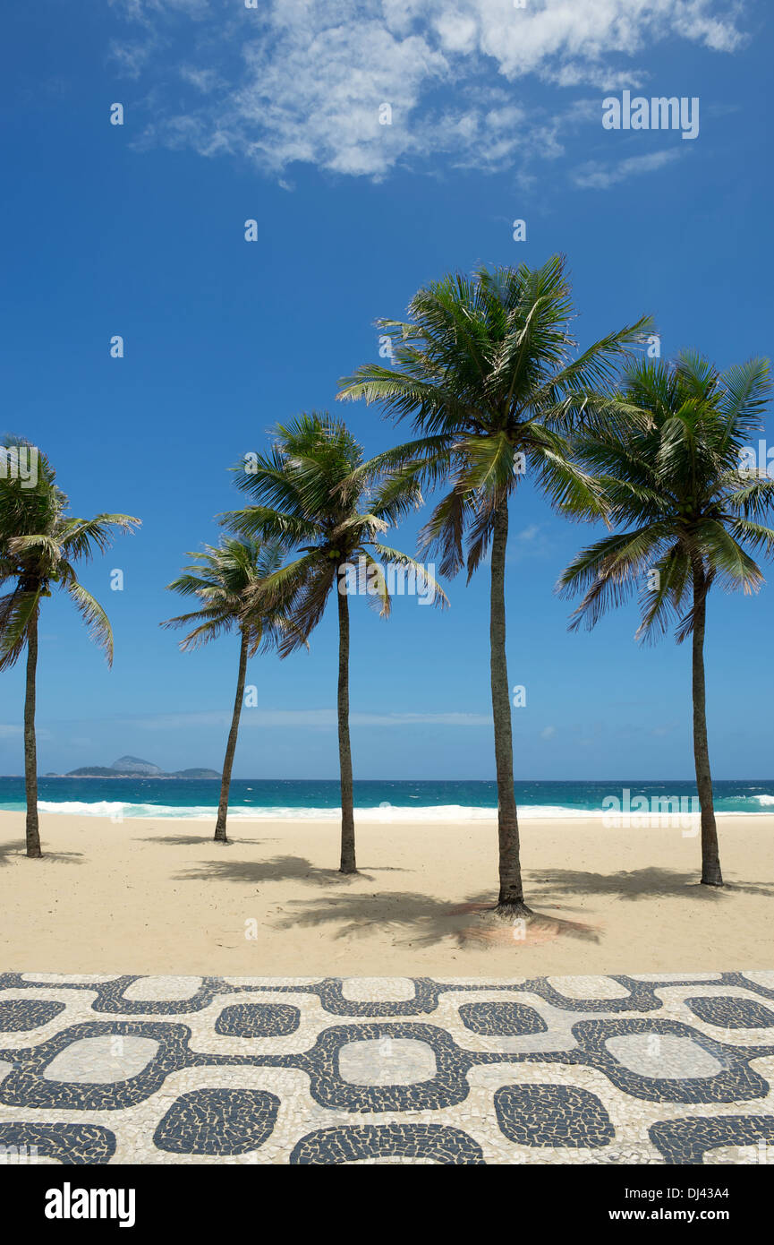 Classic view of Ipanema Beach Rio de Janeiro boardwalk with palm trees ...