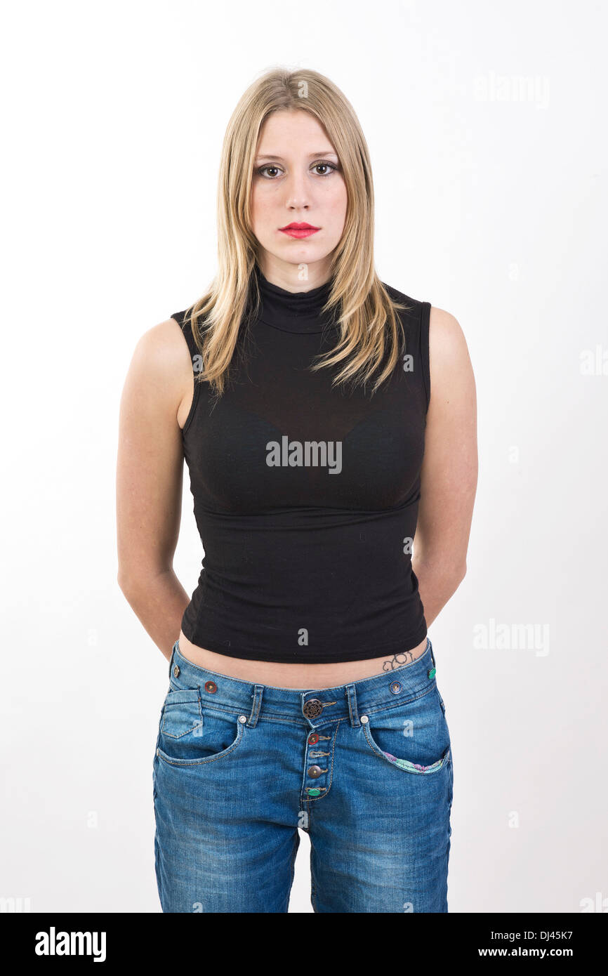 Young woman with her hands behind her back Stock Photo - Alamy