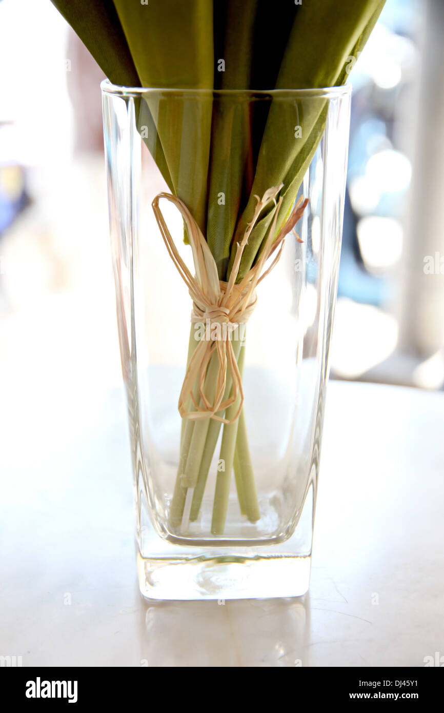 Insert the stems of the flowers into the glass Stock Photo - Alamy