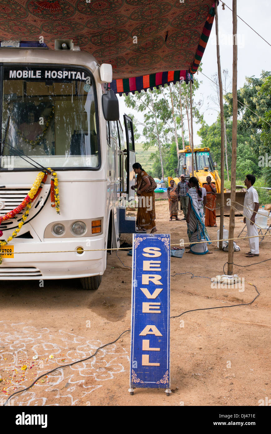 Rural Indian people entering the Sri Sathya Sai Baba mobile outreach ...