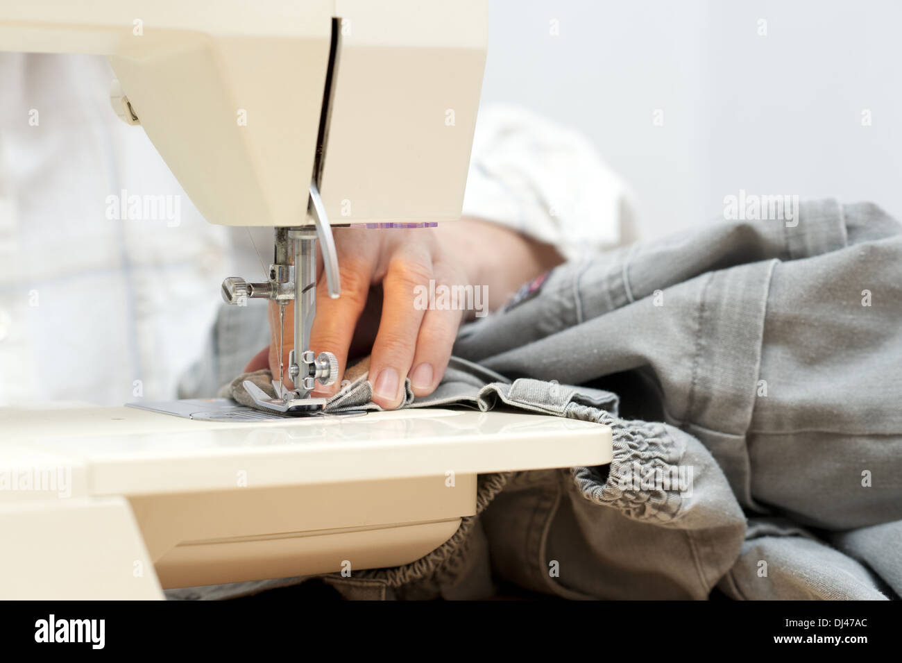 Hand and sewing machine Stock Photo - Alamy