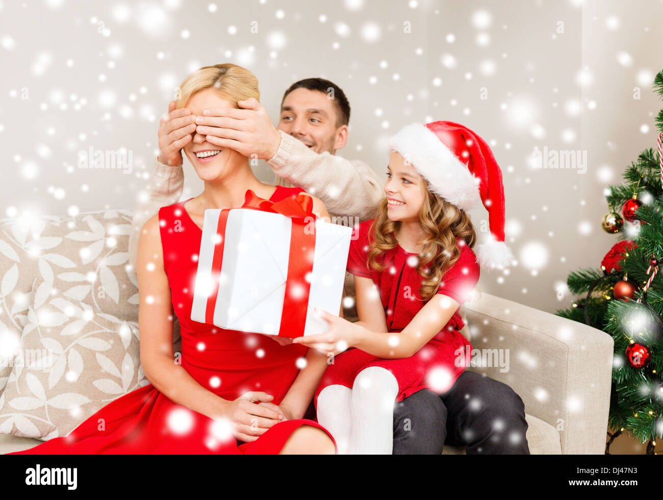 father and daughter surprise mother with gift box Stock Photo - Alamy