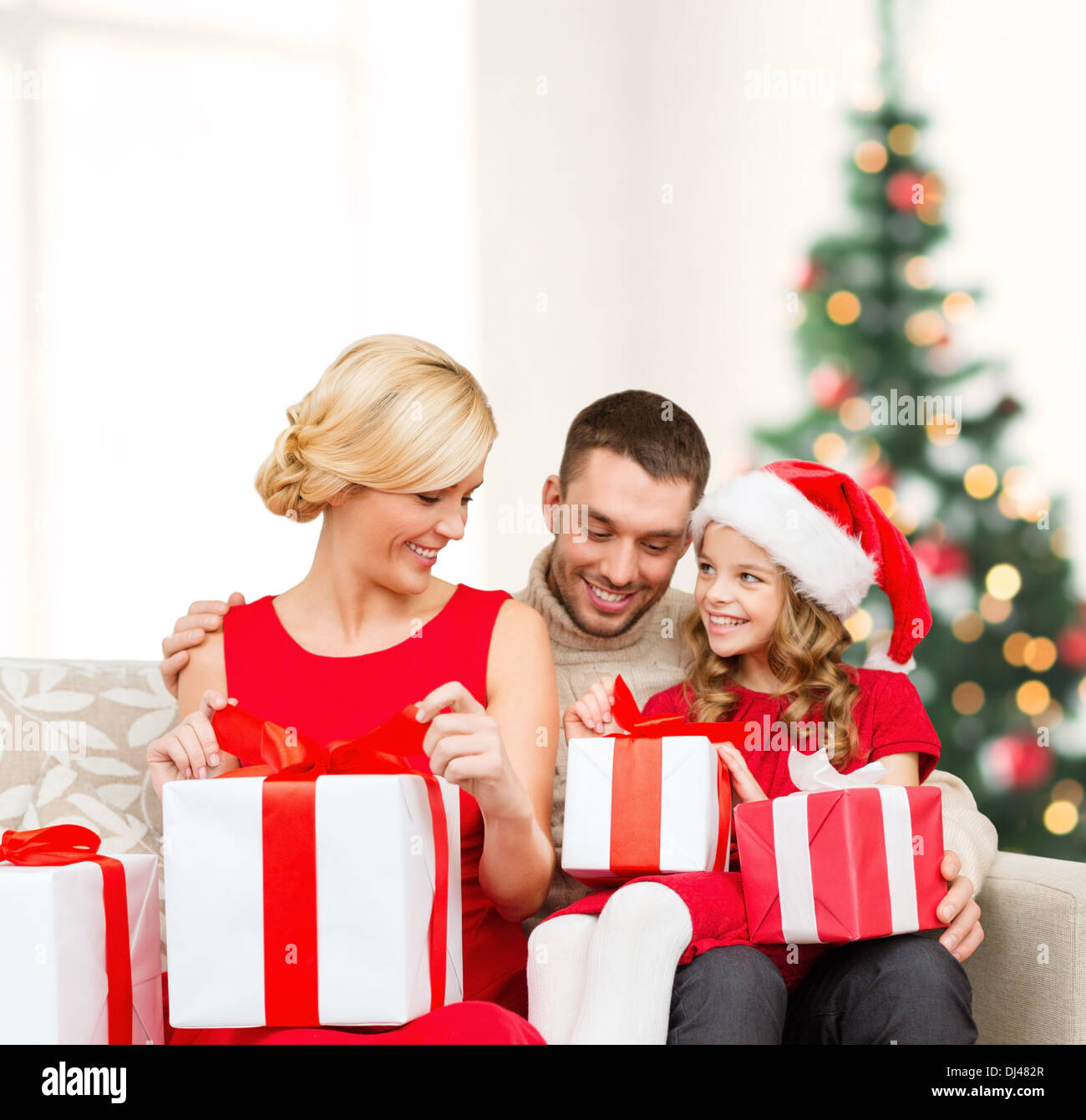 happy family opening gift boxes Stock Photo - Alamy