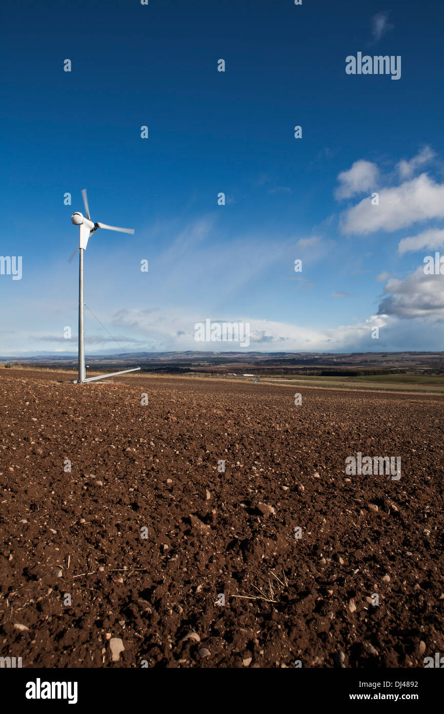 Wind turbine against a bright blue sky on a farm Stock Photo - Alamy