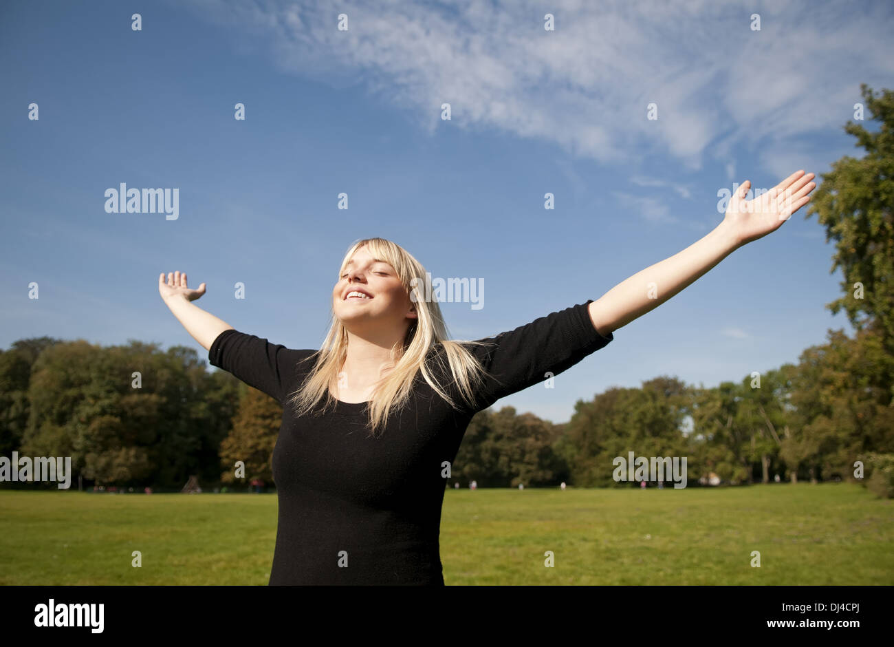 young woman spreads her arms Stock Photo - Alamy
