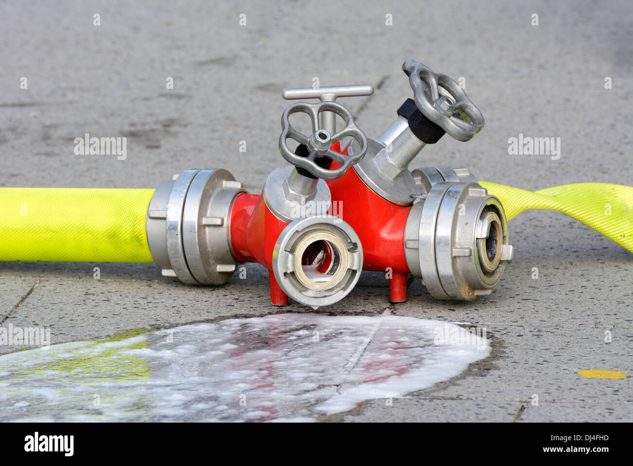 Firehose connected to a distribution device with faucet Stock Photo - Alamy