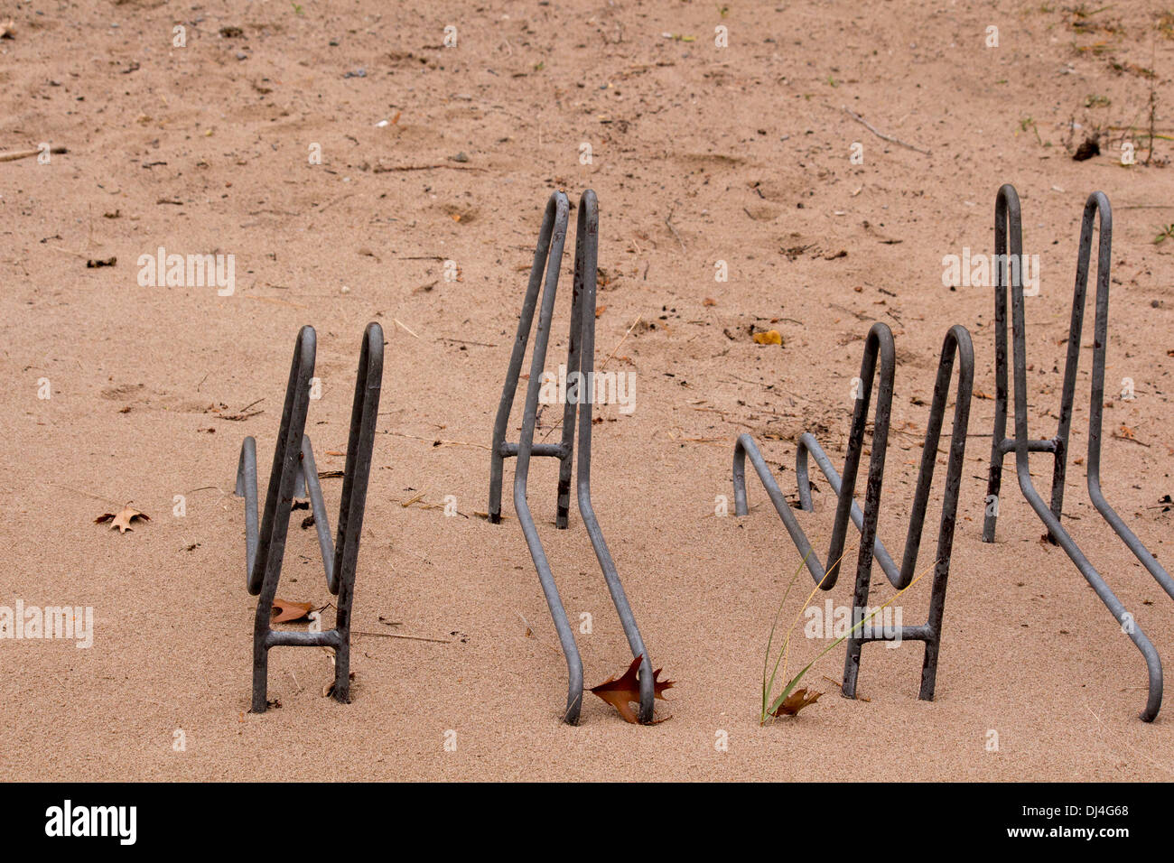 Bicycle racks on the beach surrounded by sand Stock Photo - Alamy