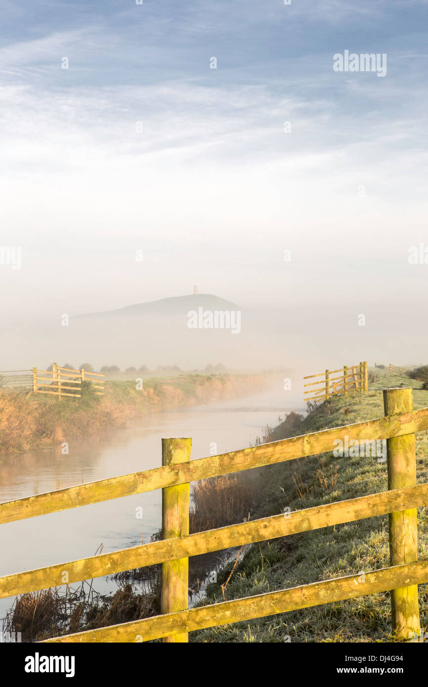 Early morning mist on the River Brue and the distant Glastonbury Tor ...