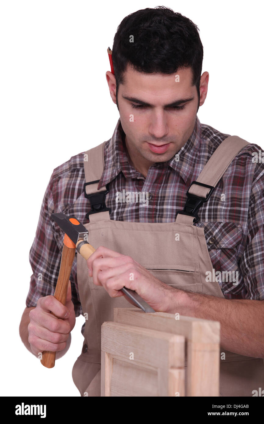 Carpenter with a hammer and a chisel Stock Photo - Alamy