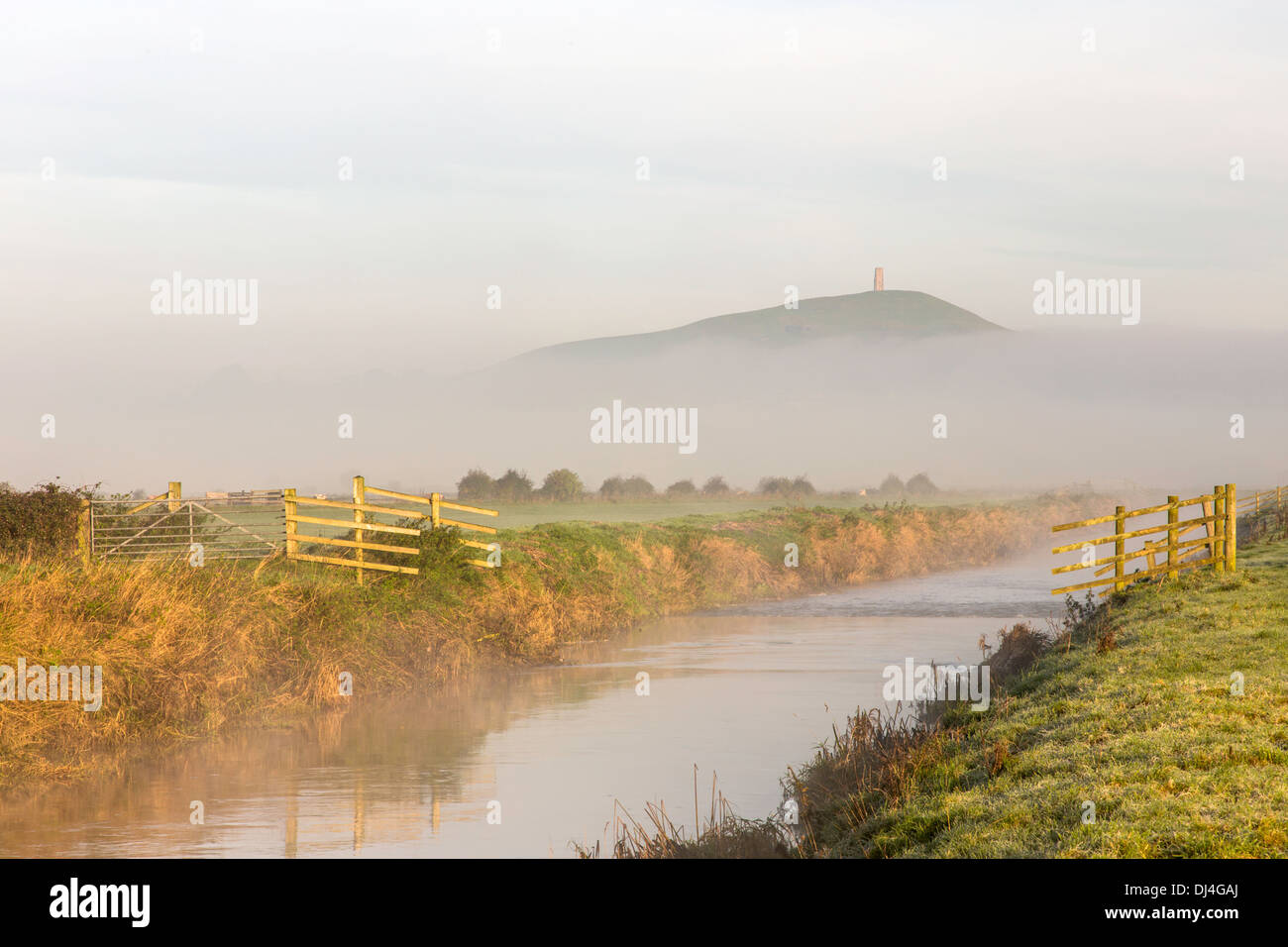 Early morning mist on the River Brue and the distant Glastonbury Tor ...