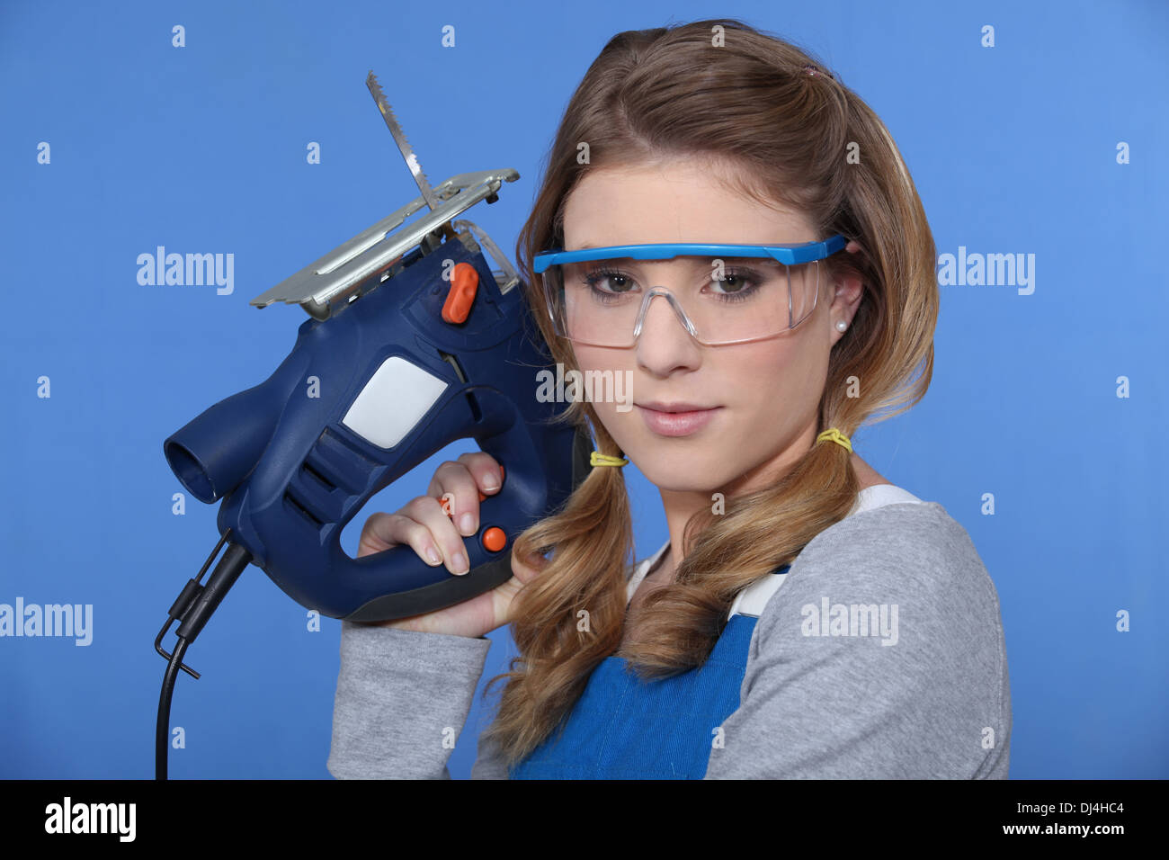 Woman with chain saw Stock Photo - Alamy