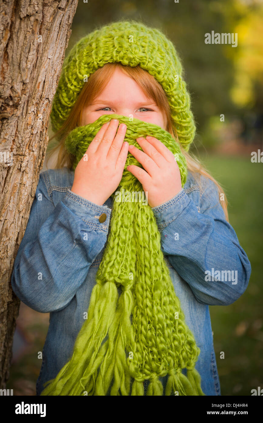 Cute Smiling Young Girl Wearing Green Scarf and Hat Posing for a ...
